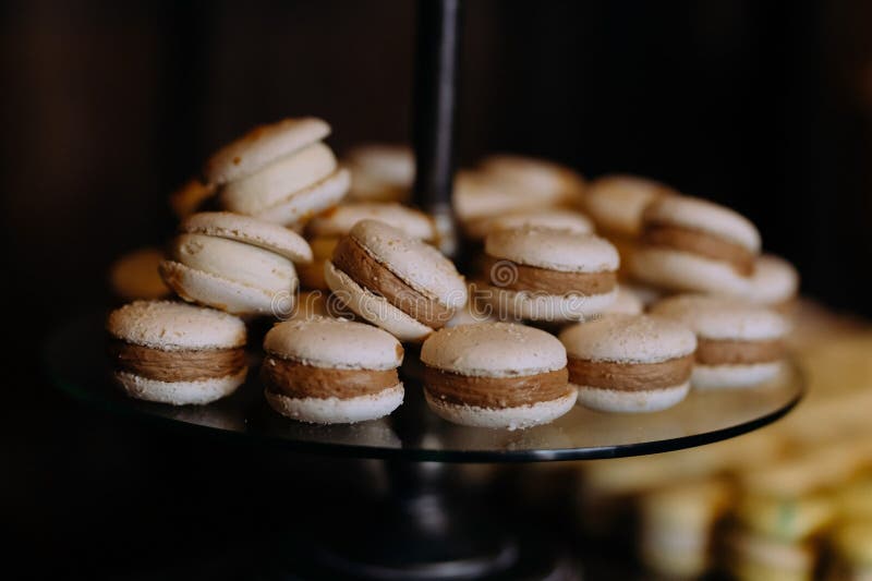 Macaroons Cakes with Cream on a Plate. Table with Sweets, Candies ...
