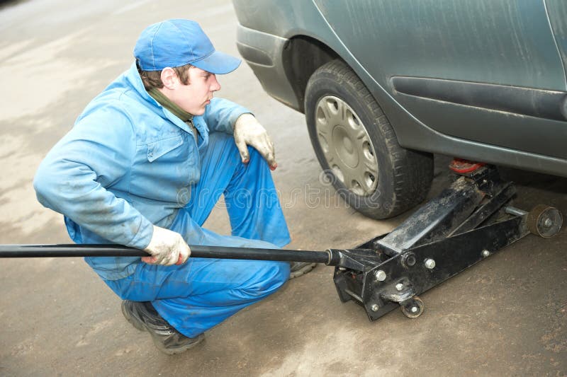 Machanic Repairman at Tyre Fitting with Car Jack Stock Photo - Image of ...