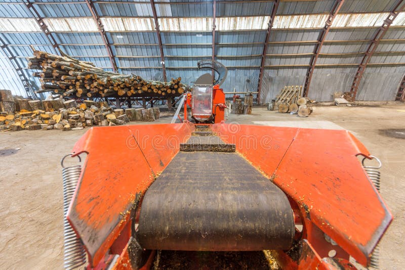 Machine for Chopping Firewood. Firewood Processor in Big Warehouse ...