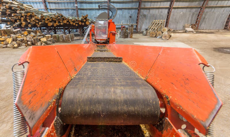 Machine for Chopping Firewood. Firewood Processor in Big Warehouse ...