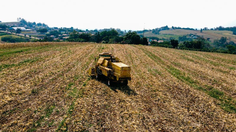 A Machine in a Field, with Hills and Trees in the Distance Stock Photo ...