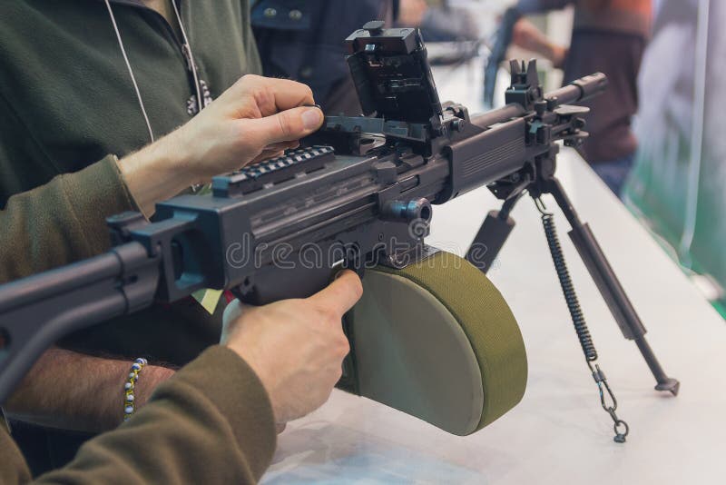 Machine Gun in the Hands of a Man Stock Photo - Image of black, gunner ...