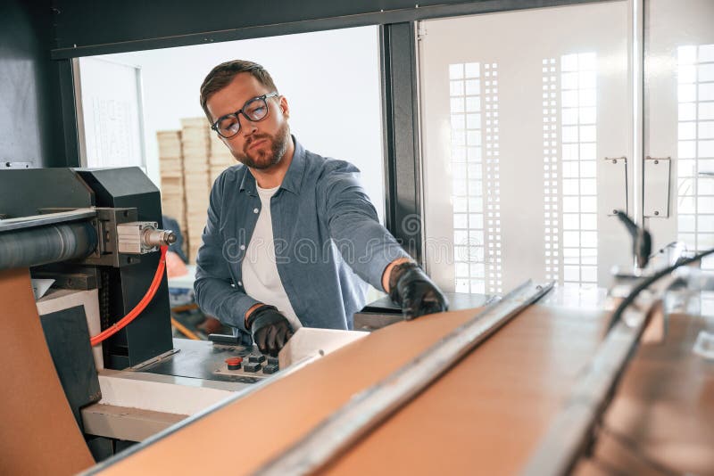 By the Machine. Handsome Man is Working at the Factory of Creating Eco ...