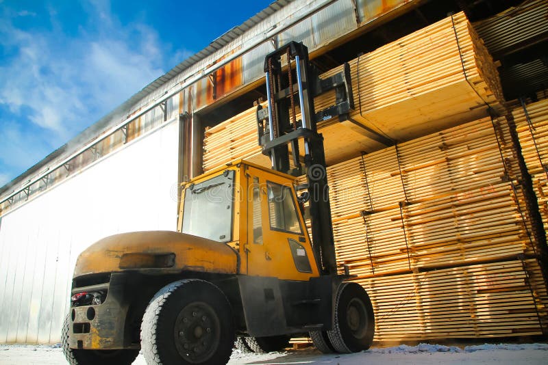 Machine is lifting lumber stock photo. Image of trailer - 94459824