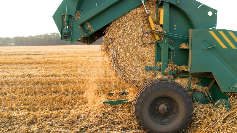Machine Making a Round Straw Bale. Stock Photo - Image of macro ...
