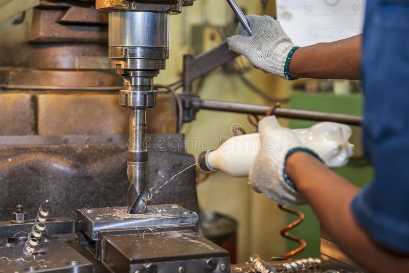 The Machine Operator Cooling the Drill Tool by Water Base Coolant with ...