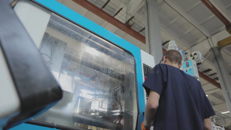 The Machine Operator Creates Parts with a Mold. Operator at the Molding ...