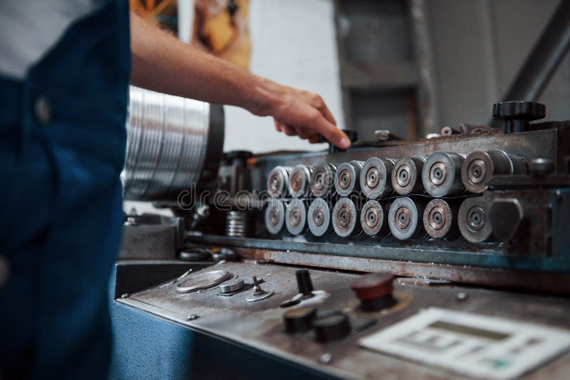 Machine Operator. Man in Uniform Works on the Production Stock Photo ...
