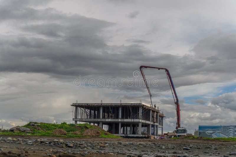 Machine for Pouring Concrete at a Construction Site on a Winter Day in ...