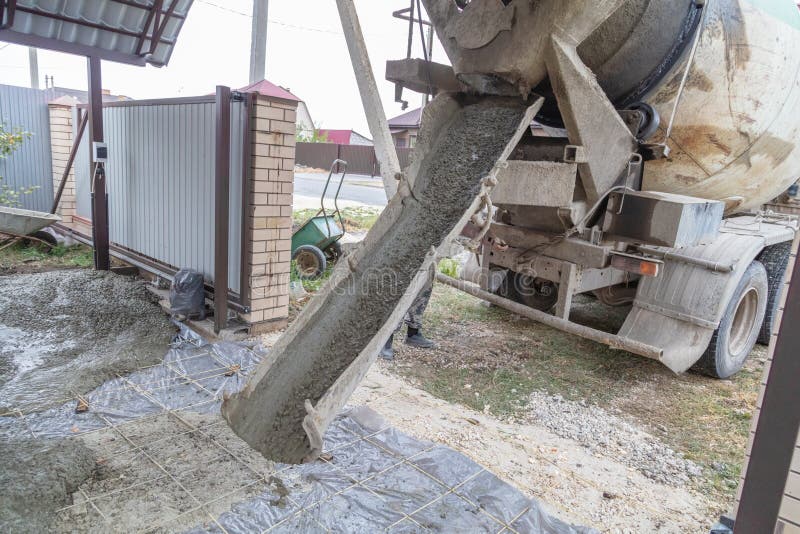 The Machine is Pouring Concrete Mix at a Construction Site. Stock Image ...