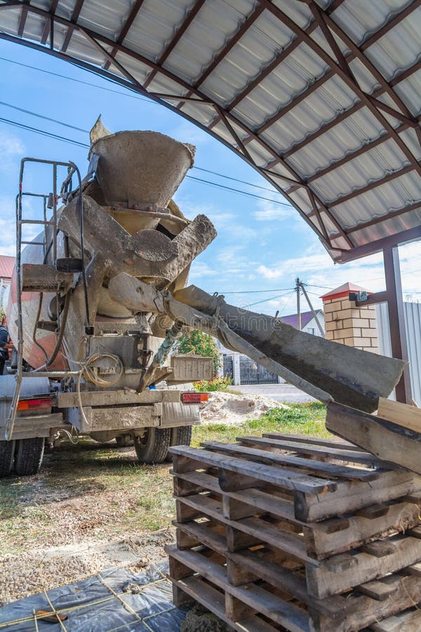 The Machine is Pouring Concrete Mix at a Construction Site. Stock Image ...