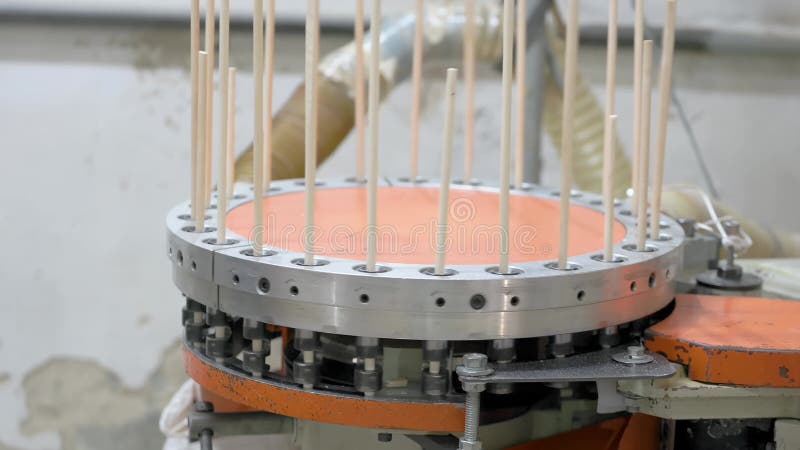A Machine Processes Wooden Dowels, Arranging Them Vertically in a ...