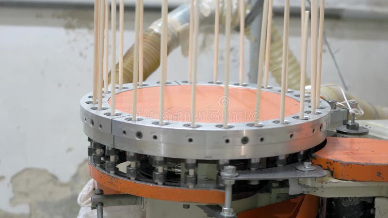 A Machine Processes Wooden Dowels, Arranging Them Vertically in a ...