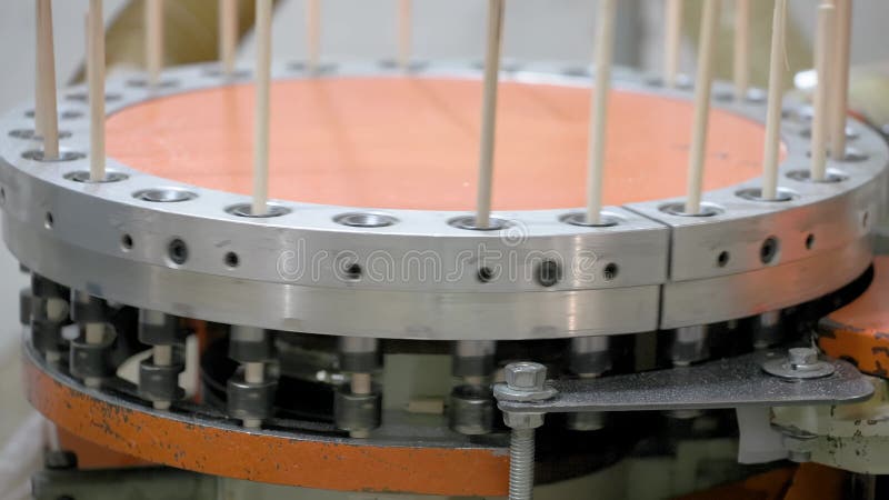 A Machine Processes Wooden Dowels, Arranging Them Vertically in a ...