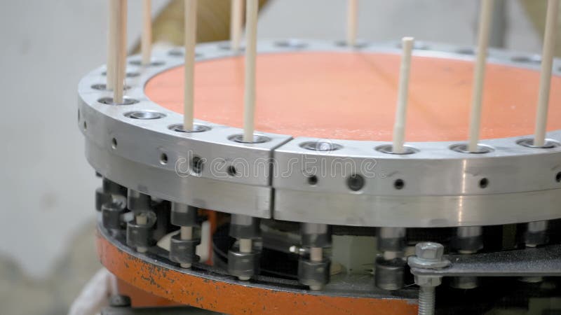 A Machine Processes Wooden Dowels, Arranging Them Vertically in a ...