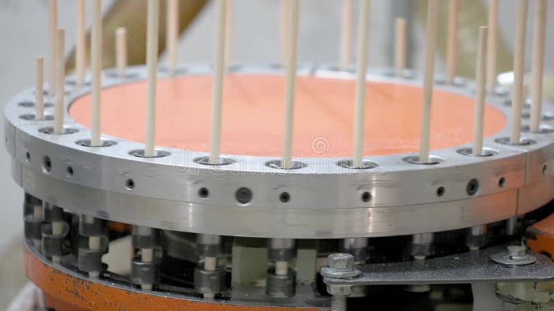 A Machine Processes Wooden Dowels, Arranging Them Vertically in a ...