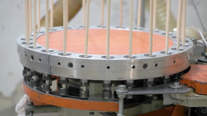 A Machine Processes Wooden Dowels, Arranging Them Vertically in a ...