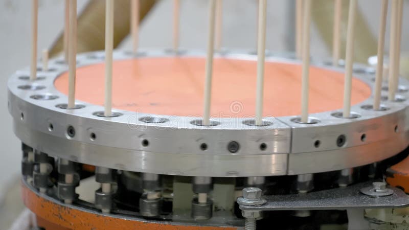 A Machine Processes Wooden Dowels, Arranging Them Vertically in a ...