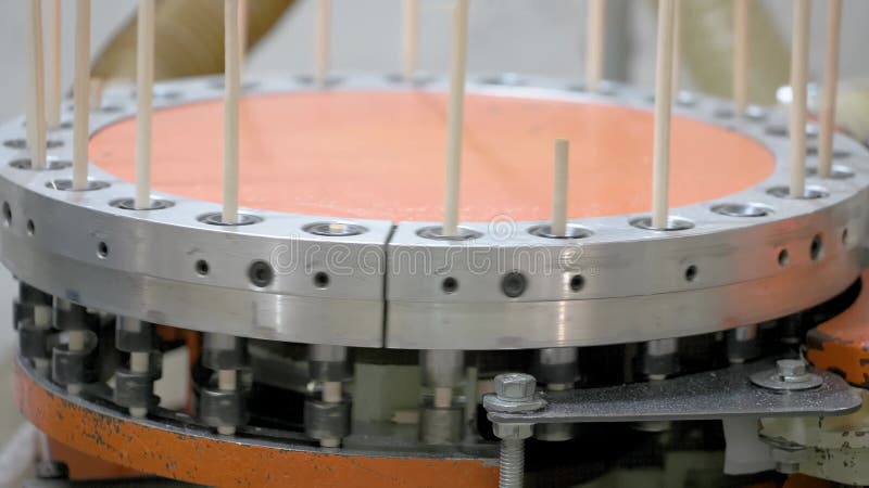 A Machine Processes Wooden Dowels, Arranging Them Vertically in a ...