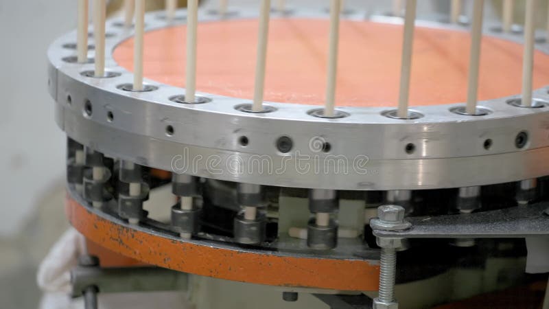 A Machine Processes Wooden Dowels, Arranging Them Vertically in a ...