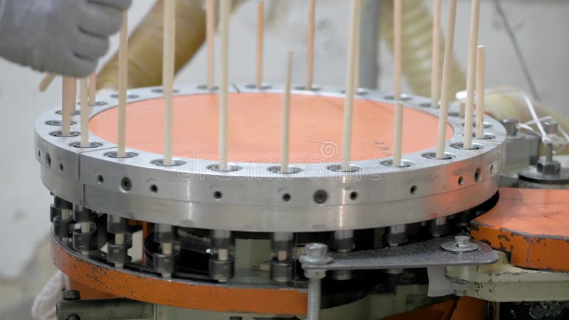 A Machine Processes Wooden Dowels, Arranging Them Vertically in a ...