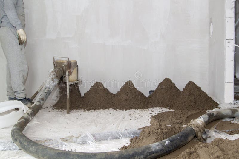 Machine Running Screed Flooring. Worker at Construction Site Sand and ...