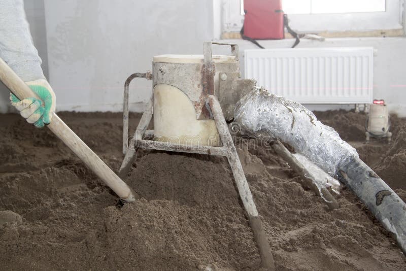 Machine Running Screed Flooring. Worker at Construction Site Sand and ...