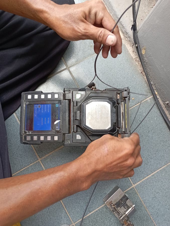 Telecom Officer is Connecting Broken Fiber Optic Cable Stock Photo ...