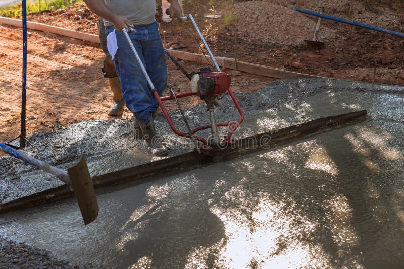 The Machine is Used To Align the Compacted Layer of Fresh Concrete on a ...