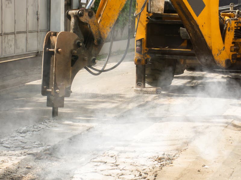 Machine is Working To Drill the Concrete Pavement Causing Dust Smoke ...