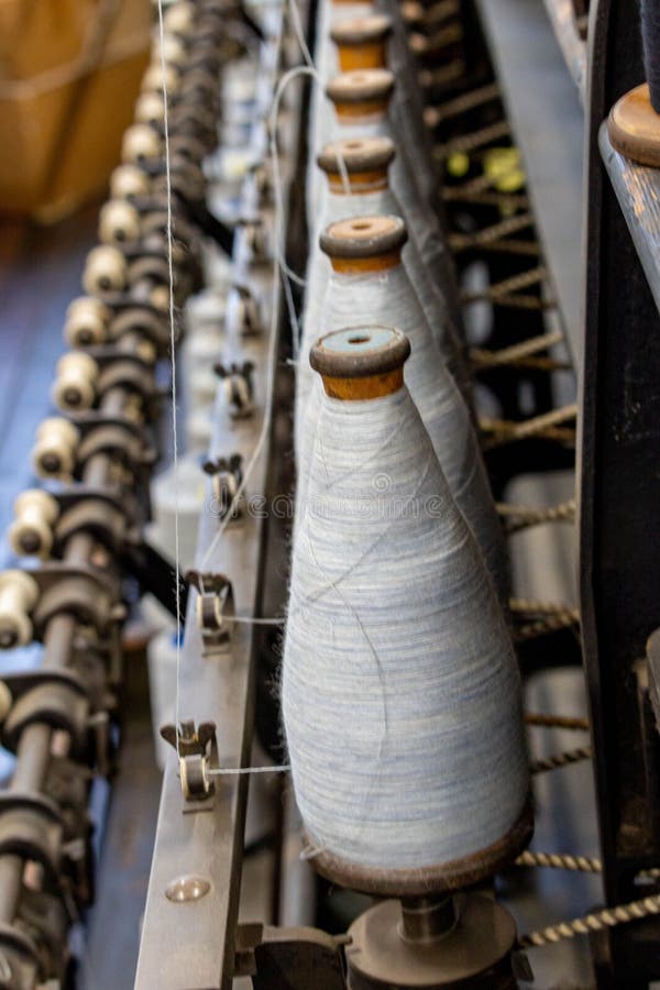 A Machine is Working on a White Yarn Spinning with Cones Stock Photo ...