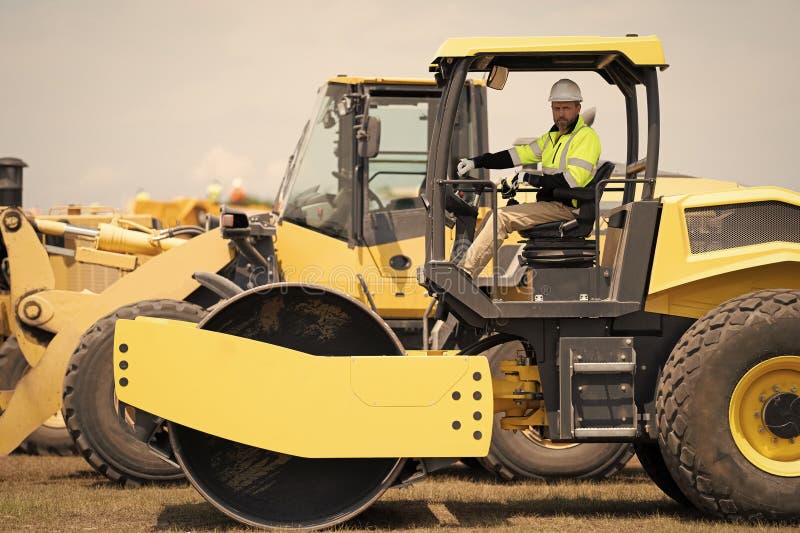 Machinery in a Industry with Hispanic Construction Worker. Construction ...