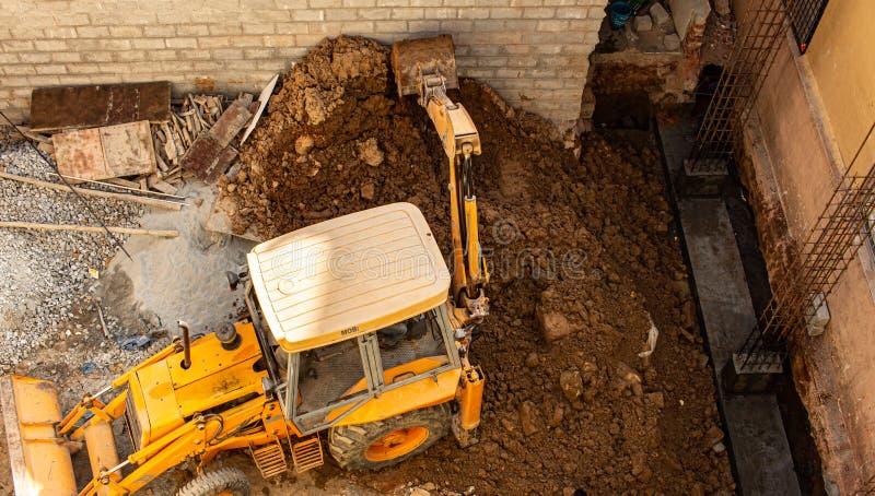 Machinery at Work in a Construction Site Moving the Clay Soil Stock ...
