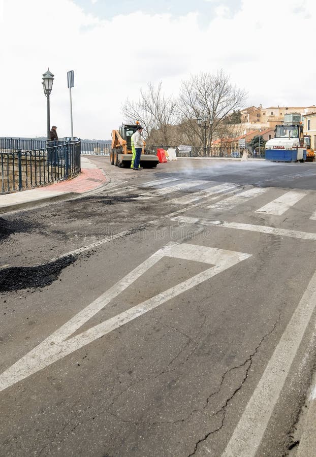Machines Performing Asphalting and Paving Work on a City Road ...