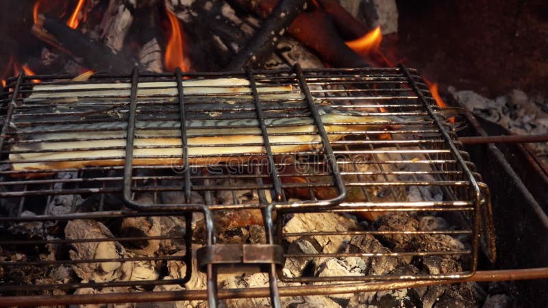 Mackerel Fish Fillet is Flipped on the Grill Grid Over the Flames Stock ...