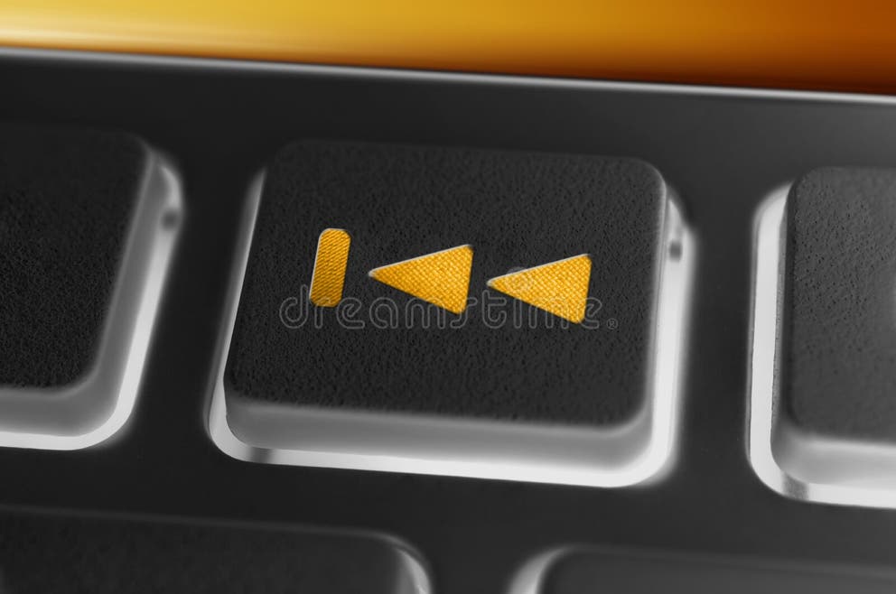 Macro of a Black Skip Backward Button of a Black Remote Control with ...