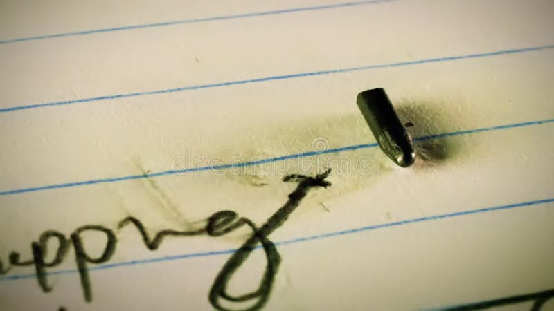 Macro: a Broken Pencil Tip / Head Rolls into Place on a School Paper ...