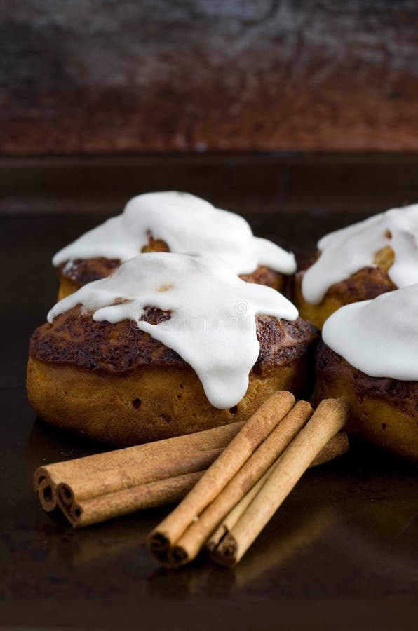 Macro of Cinnamon Buns with White Icing and Cinnamon Sticks Stock Image ...