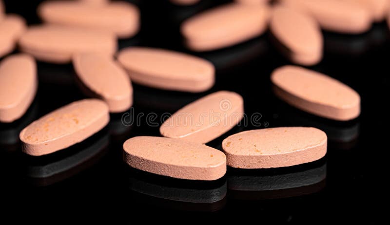 Close Up of Multi Vitamin Tablet on a Reflective Black Backgroun Stock ...
