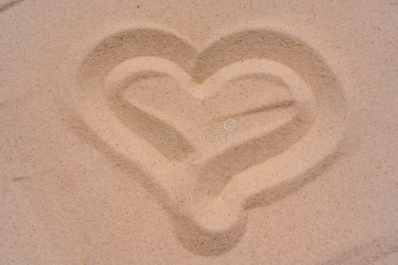 Macro Close Up Sand Texture with a Finger-drawn Heart. Background from ... Macro Close Up Sand Texture with a Finger-drawn Heart. Background from ...