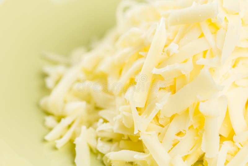 Macro of Grated Cheese Pile on the Green Plate Stock Image - Image of ...