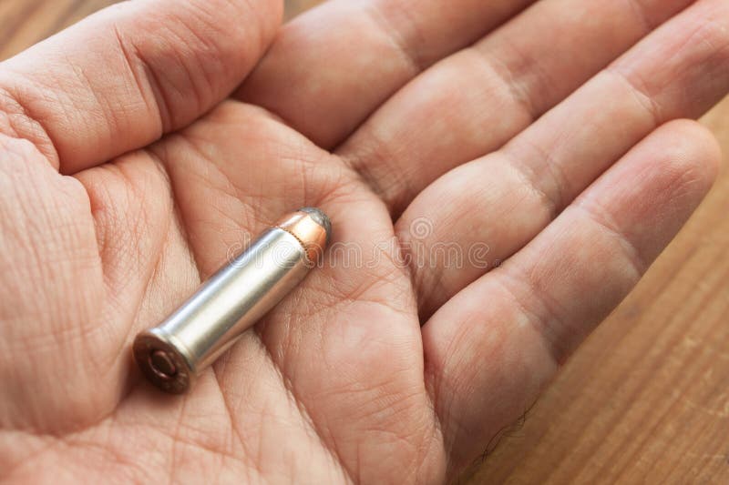 Single .38 bullet stock photo. Image of wood, slug, hand - 29829020