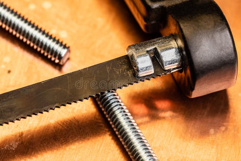 A Macro Image of a Hacksaw Blade Above a Steel Cut in Half on a Worn ...