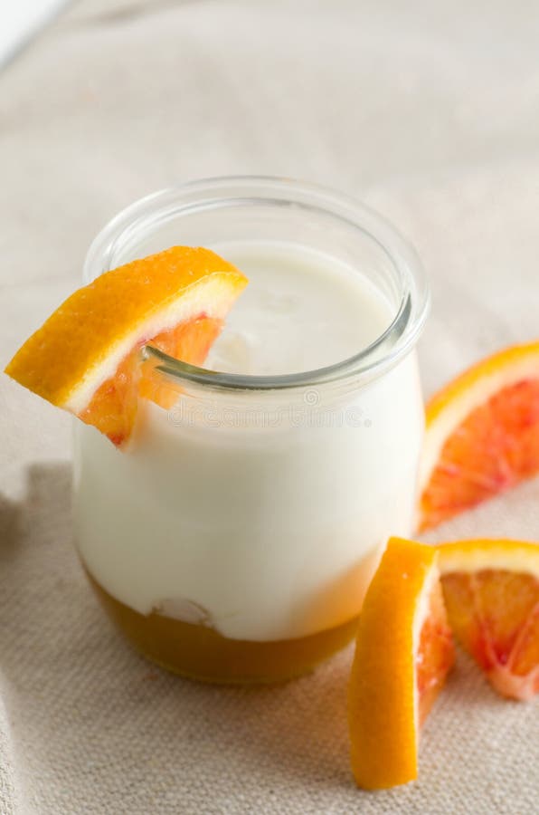 Macro Image of Nature Yogurt in a Small Glass Jar and Orange Slices ...