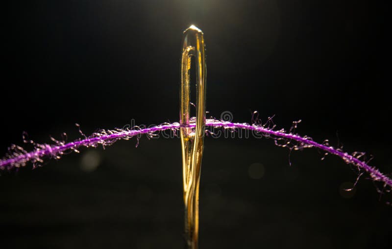 Macro Image of a Needle Eye Threaded with Piece of Purple Thread on ...
