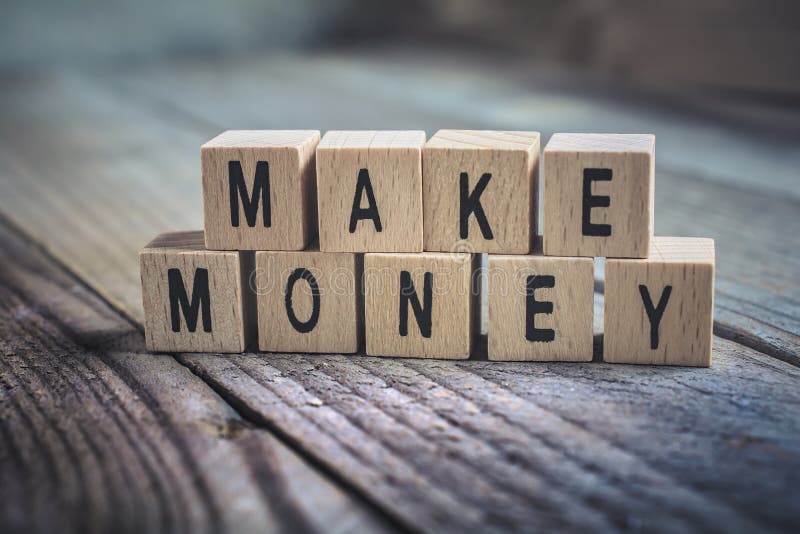 Macro of a Make Money Reminder Formed by Wooden Blocks on a Wooden ...