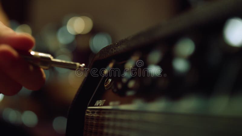 Sound Engineer Hand Connecting Plug To Amplifier in Late Night ...
