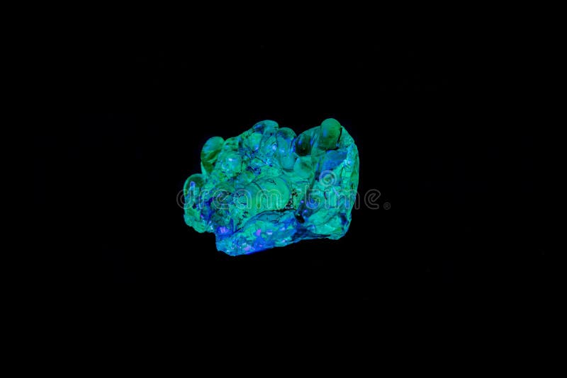 Macro Mineral Stone Opal Under Ultraviolet Light on a Black Background ...