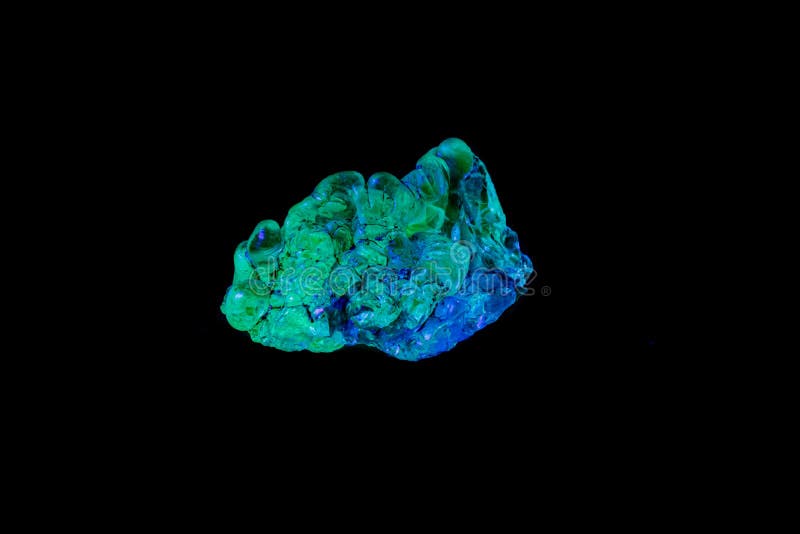 Macro Mineral Stone Opal Under Ultraviolet Light on a Black Background ...