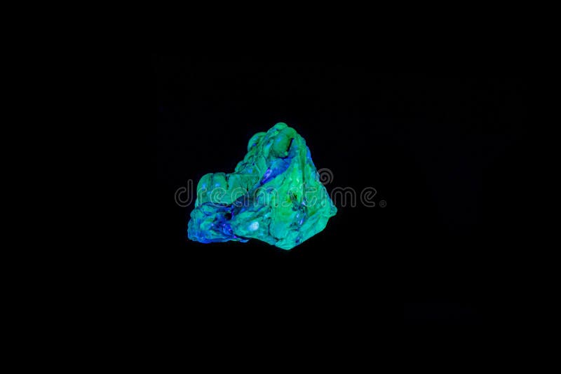 Macro Mineral Stone Opal Under Ultraviolet Light on a Black Background ...